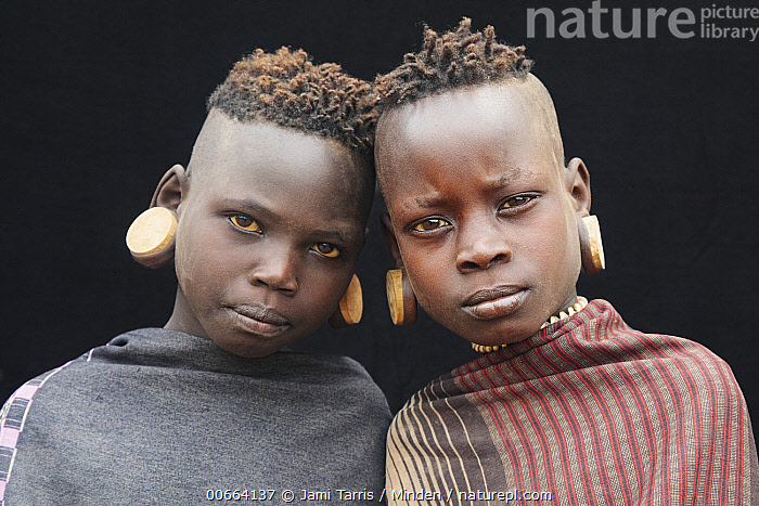 Stock photo of Two Mursi tribe girls wearing ear plates in their ...