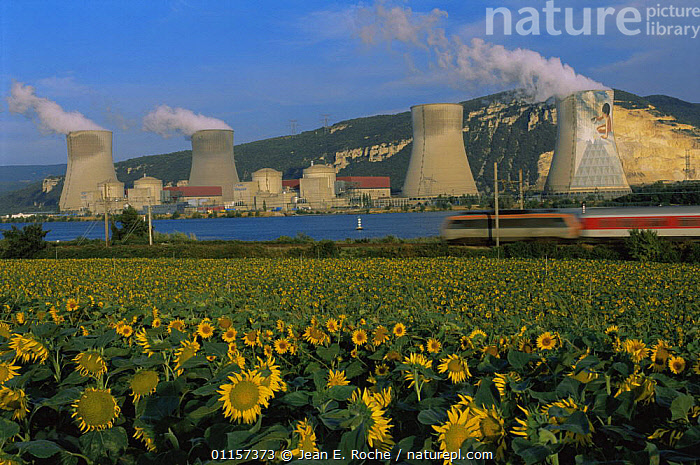 Stock photo of Train passing electricity power station with field of ...