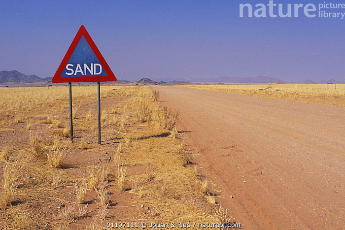 Stock photo of Sign warning of the danger of sand on the road, Namib ...