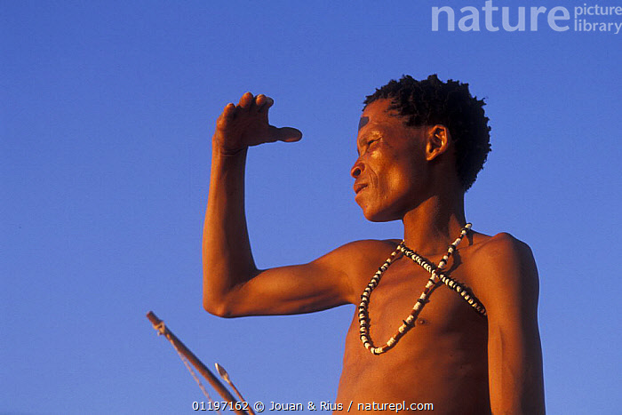 Stock photo of Bushman San looking into the distance shading face with ...