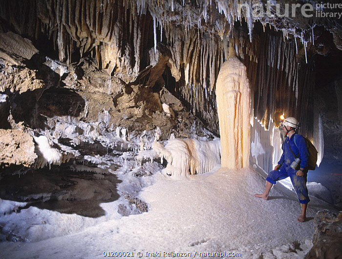 Stock photo of Potholer walking on mounds of salt crystals in cave ...