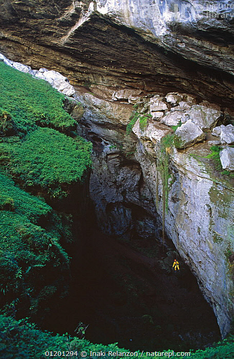 Stock photo of Potholer being lowered down into underground cave system ...