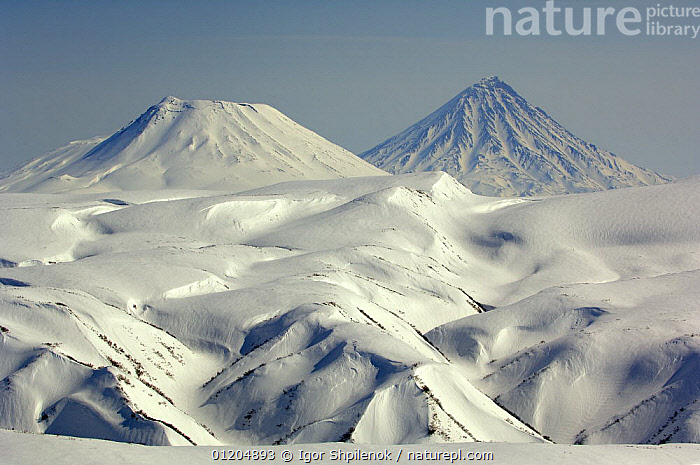 Stock photo of Snow-covered Kronotsky and Krashennikov volcanoes in ...