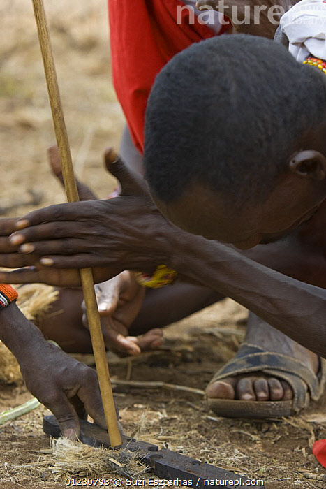 Stock photo of Maasai man creating fire by turning a stick, Laikipiac ...