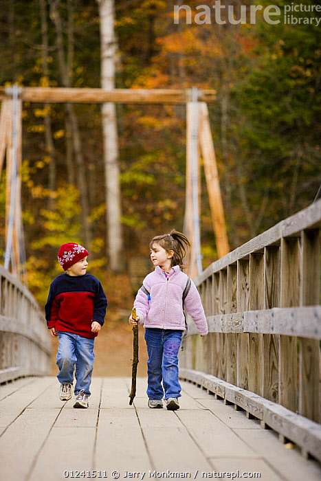 Stock photo of Two children (ages 4 and 6) walking across a wooden ...