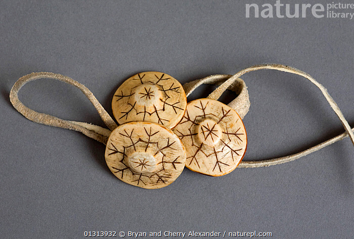 Stock photo of Three decorated buttons carved from mammoth ivory and ...