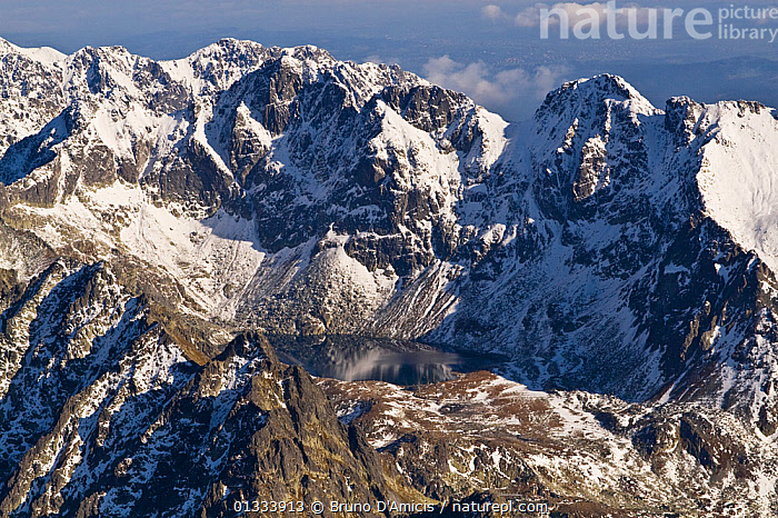 Stock photo of Aerial view of corrie lake surrounded by mountain peaks ...