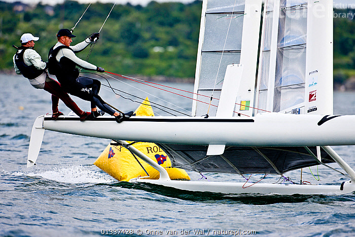 Stock photo of Crew trapezing on board C-Class catamaran during ...
