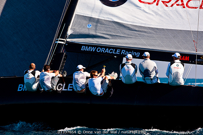 Stock photo of Crew hiking-out on board yacht during a race in the RC44 ...