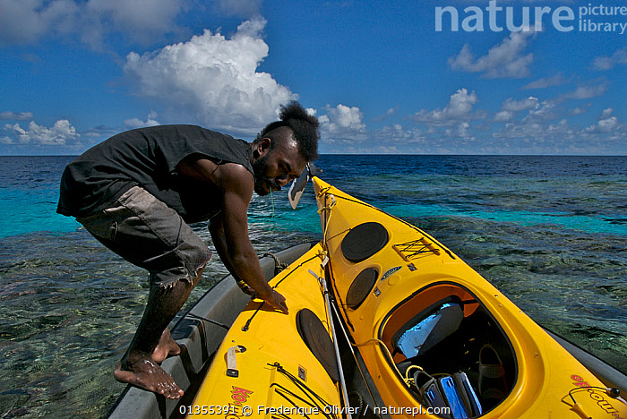 Stock photo of Man loading demountable kayak into banana boat, Solomon ...