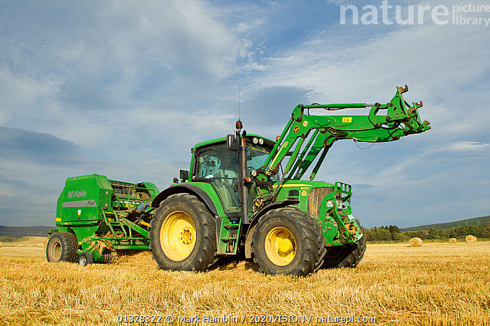 Stock photo of Baling machine and tractor collecting Barley straw on ...