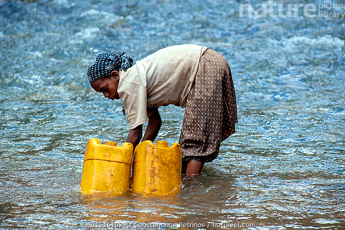 Stock photo of Oromo tribe girl filling her yellow water containers ...