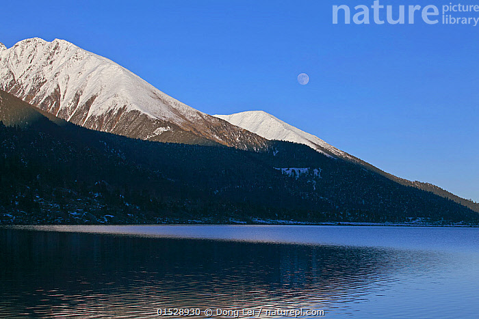 Stock photo of Mountain landscape reflected in lake, Basongcuo National ...