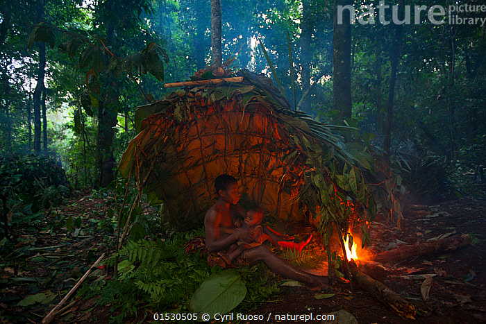 Stock photo of Baka Woman and child in Mongolu, a hut made from sticks ...