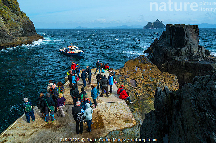 Stock photo of People standing on harbour wall at Skellig Michael ...