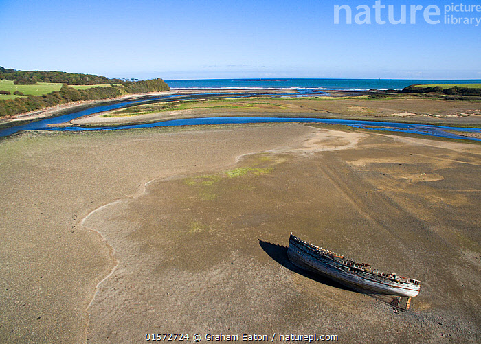 Stock photo of Shipwreck remains in estuary blocked by sandspit, Traeth ...