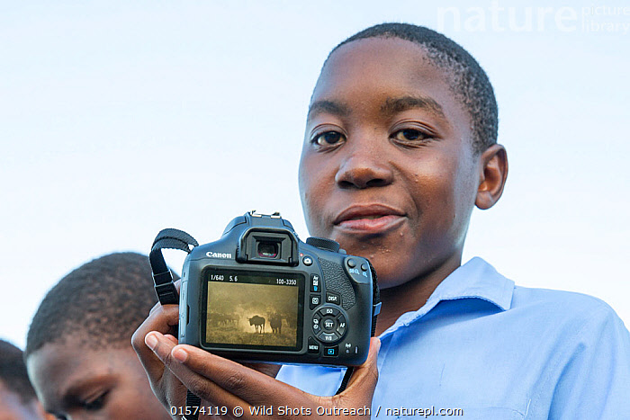 Stock photo of Wild Shots Outreach Student Ricky Tibane showing picture ...