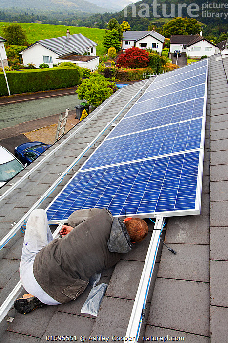 Stock photo of Technicians fitting solar photo voltaic panels to a ...