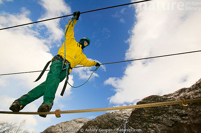 Stock photo of A climber crossing the steal rope bridge in glen Nevis ...