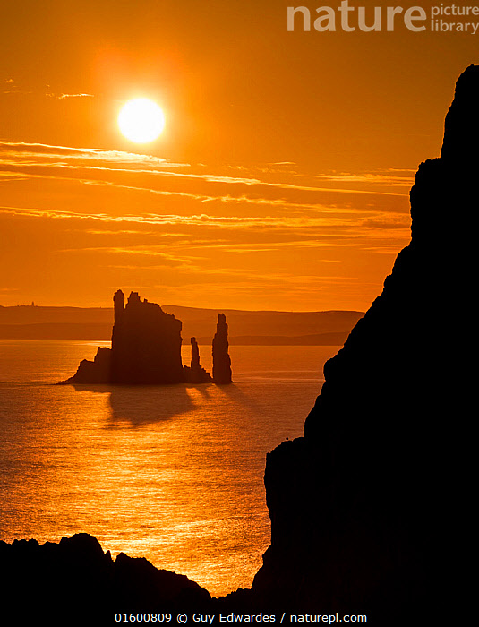 Stock photo of The Drongs sea stacks silhouetted at sunset, Hillswick ...