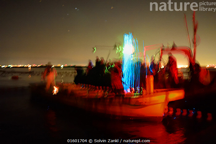 Stock photo of Fisherman haul up glowing nets of florescent Firefly ...