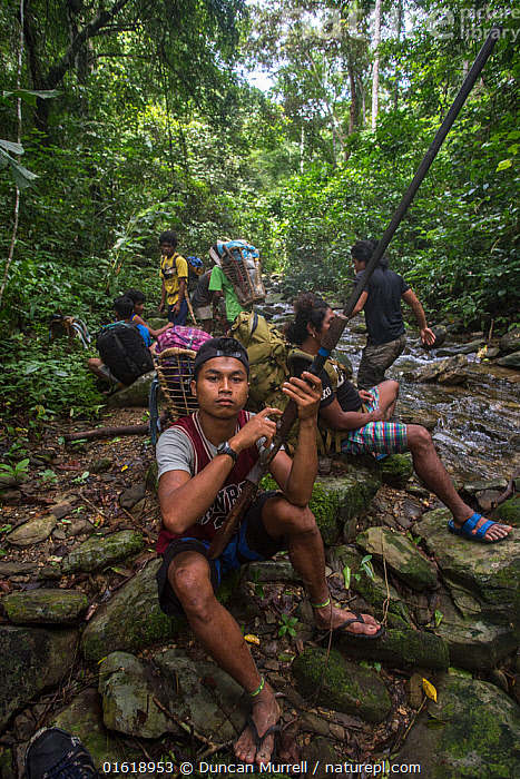 Stock photo of Young Batak man holding a home-made hunting rifle on an ...