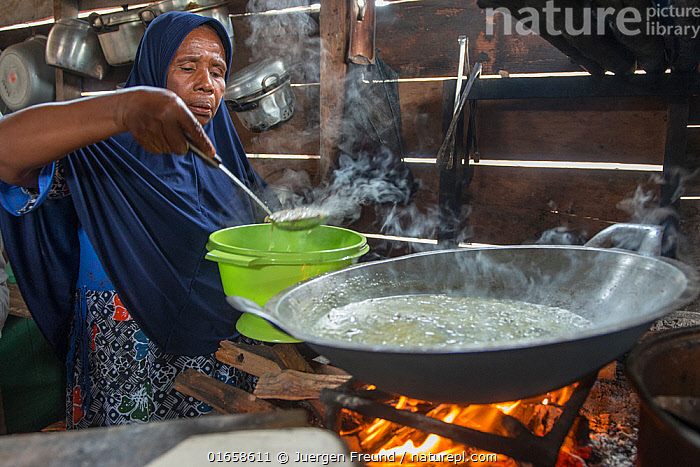 Stock photo of Woman cooking sago dish over open fire, a starch staple ...