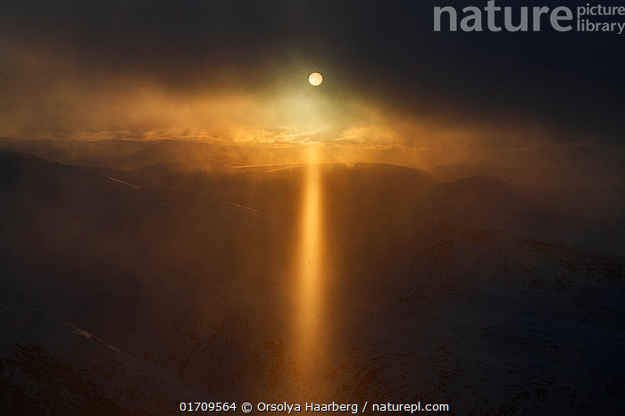 Stock photo of Sun pillar appearing during light snowfall at sunset ...
