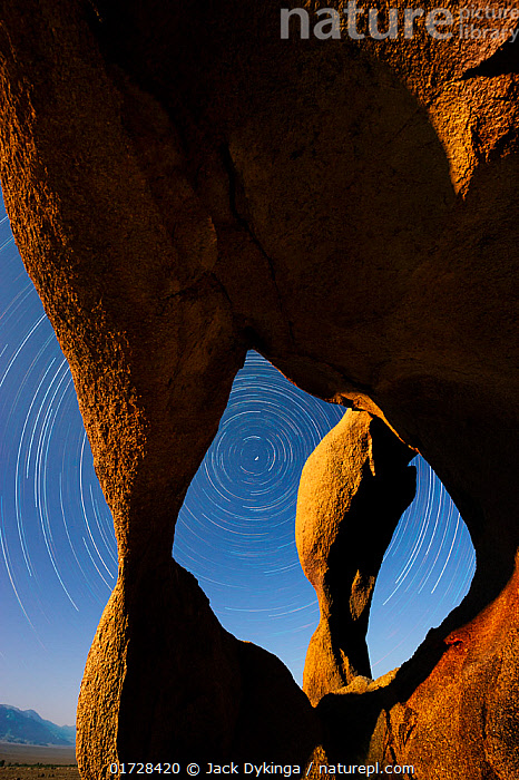 Stock photo of Triple Arch eroded granite formation at night against ...